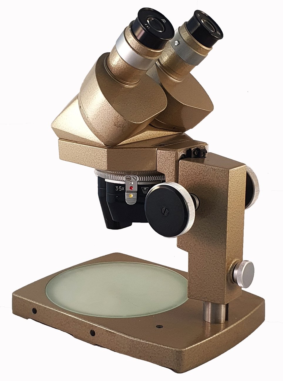 A gold microscope with a lensDescription automatically generated