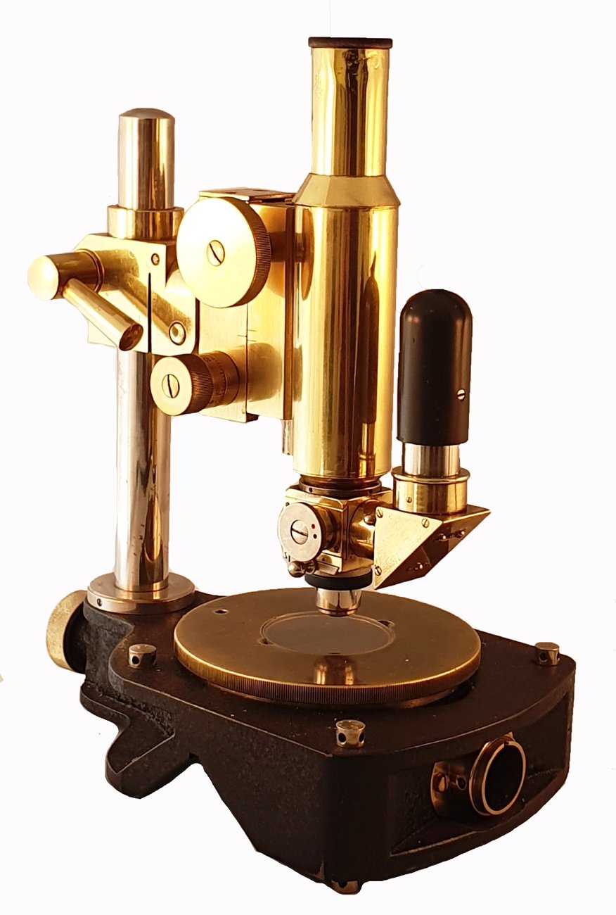 A gold and black microscopeDescription automatically generated
