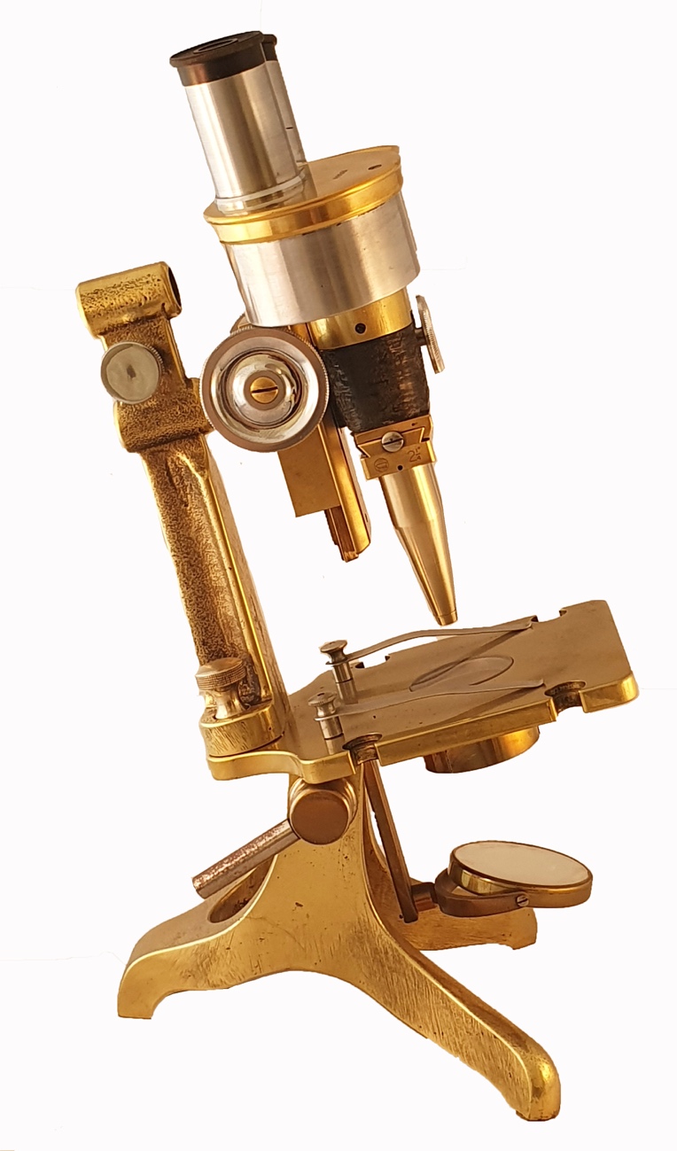 A close-up of a gold microscopeDescription automatically generated