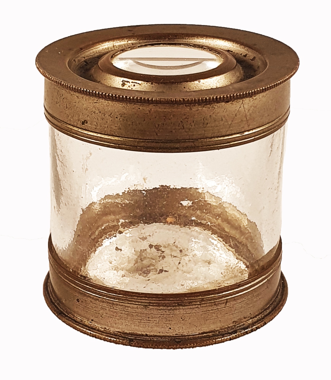 A glass container with a round lidDescription automatically generated