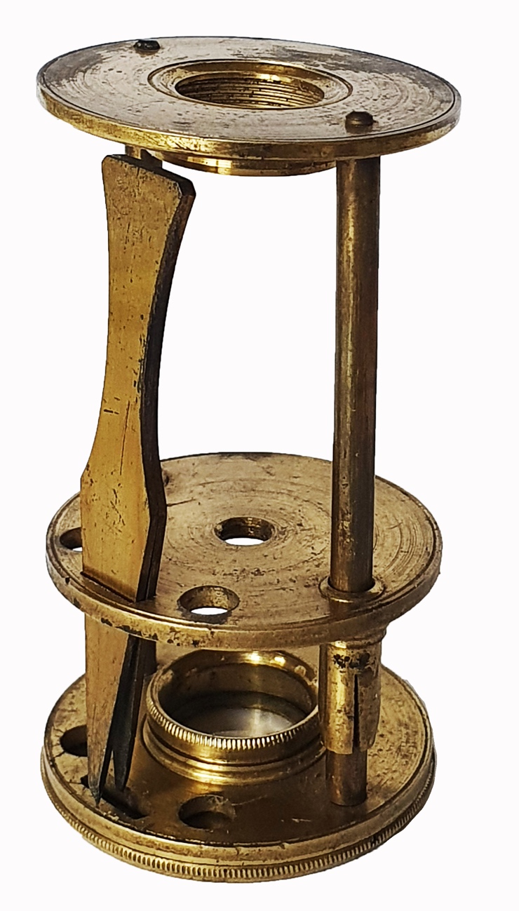 A gold metal object with a long handleDescription automatically ...