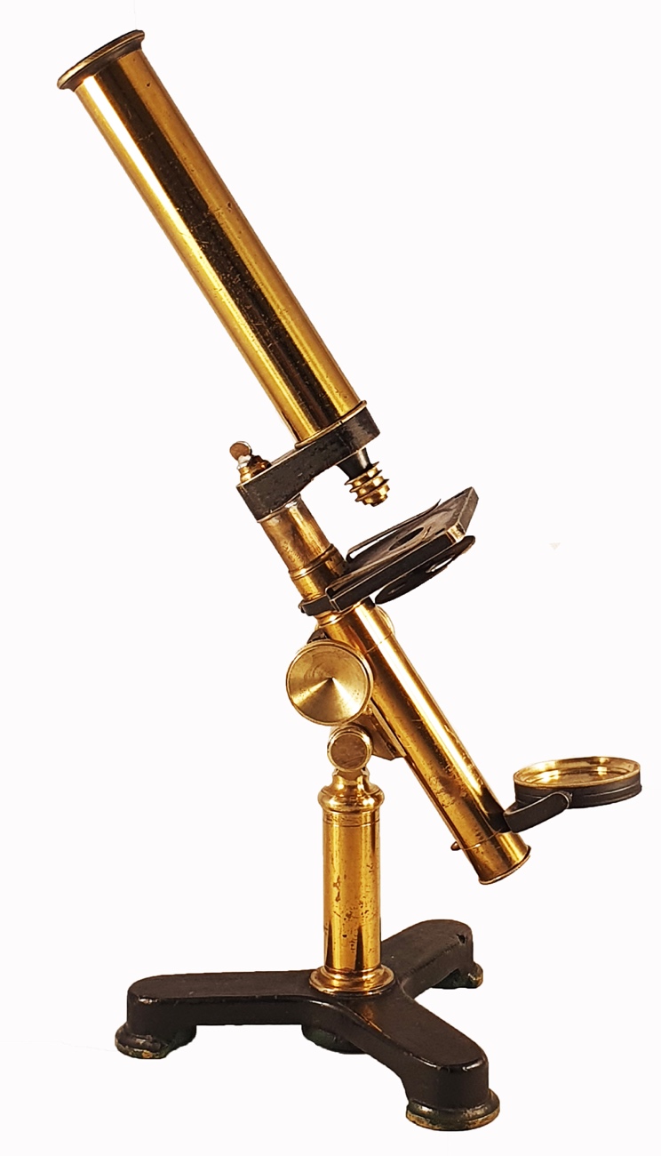 A close-up of a gold microscopeDescription automatically generated