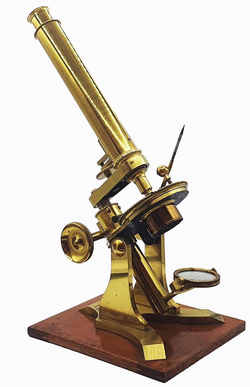 A gold microscope on a white backgroundDescription automatically generated